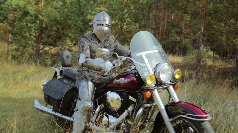 A Medieval Knight in Full Armor Sits on a Motorcycle Against the ...