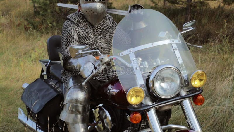 A Medieval Knight in Full Armor Sits on a Motorcycle Against the ...