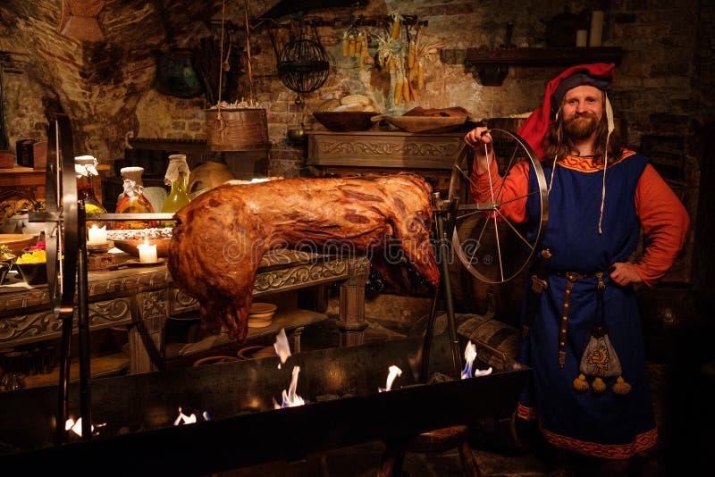 Medieval Man Doing Roasted Pig on the Rack in Ancient Castle Kit Stock ...