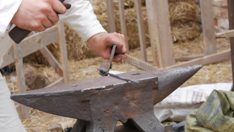 Medieval Method of Forging Iron, the Blacksmith Forges an Iron Nail ...