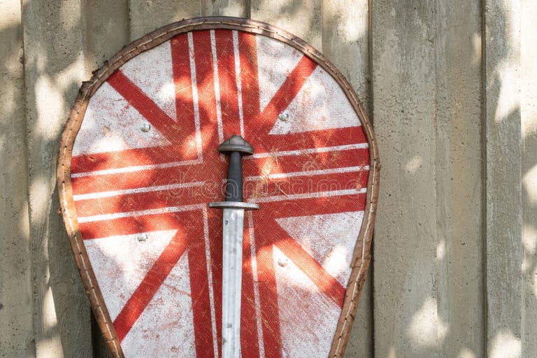 Medieval Shield with Red Patterns and Norman Sword in Front of Rustic ...