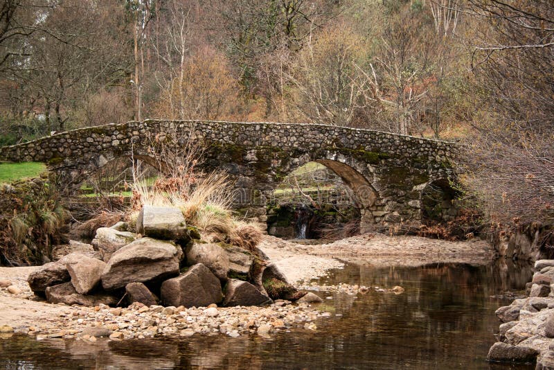 Medieval Stone Bridge Over River and Trees in the Background Stock ...