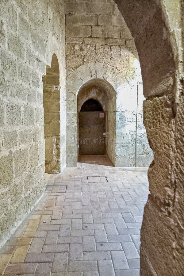 Medieval Stone Hallway with Arched Doorways and Textured Walls Stock ...