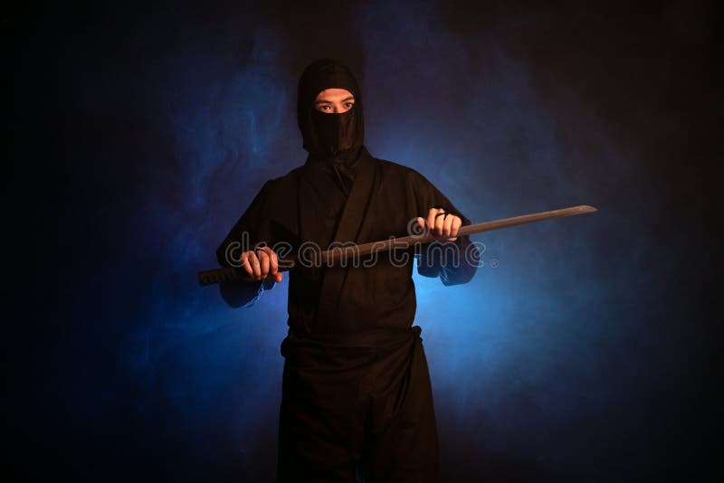 Medieval Warrior Assassin Ninja with Sword in Aggressive Pose in Smoke ...