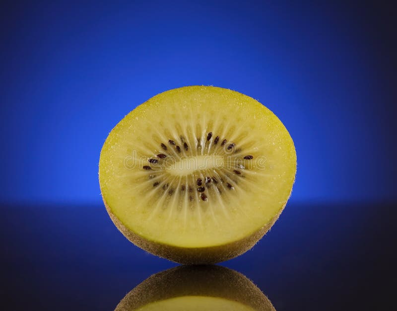 Medio kiwi en azul imagen de archivo. Imagen de travieso - 11740129