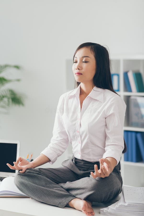 Meditating on Office Desk stock image. Image of entrepreneur - 112815337