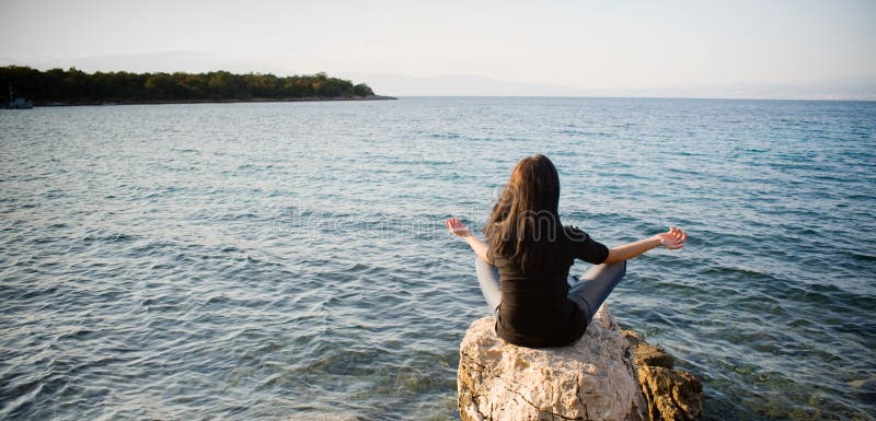Meditating by the sea stock image. Image of rest, healthy - 6574849