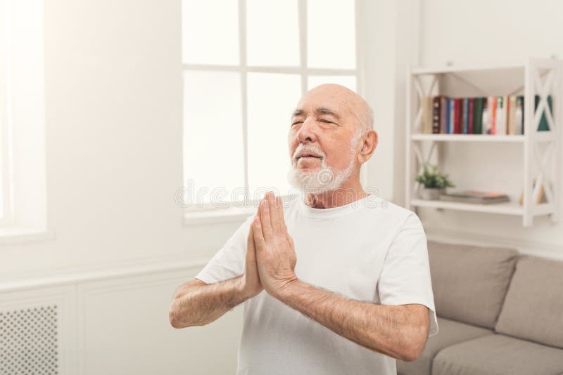 Meditating Senior Man with Praying Hands Indoors Stock Image - Image of ... Meditating Senior Man with Praying Hands Indoors Stock Image - Image of ...
