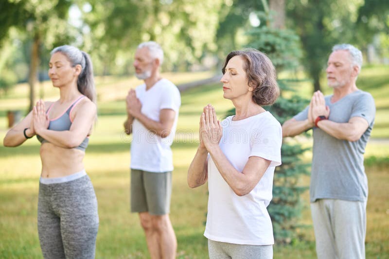 Group of People Meditating Together in Park Stock Photo - Image of ...