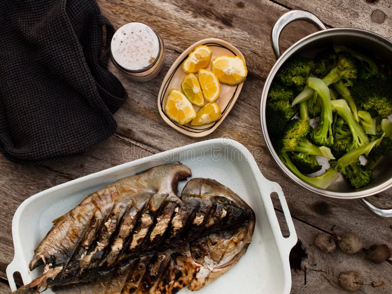 Mediterranean Fire Cooked Fish on Rustic Wooden Table Stock Image ...