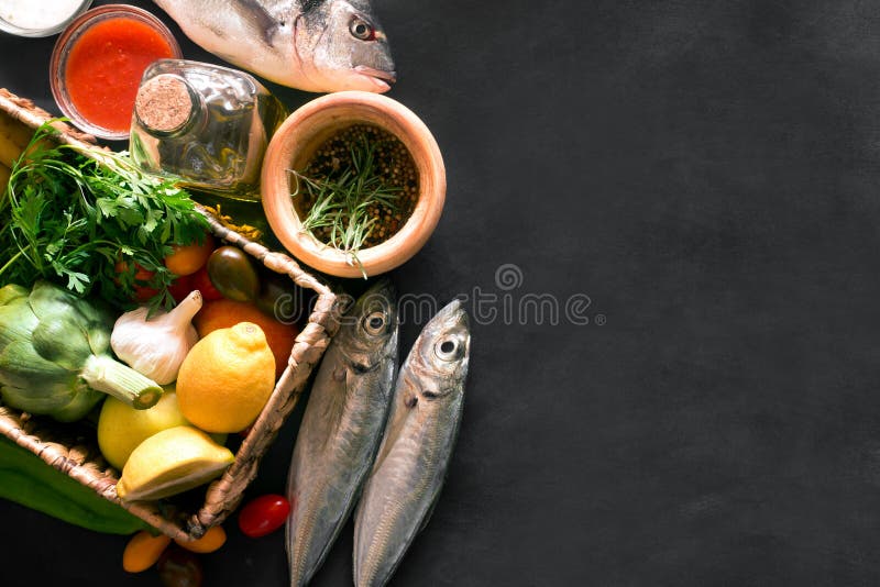Mediterranean Fish - Dorado and Vegetables on the Chalkboard. Top View ...