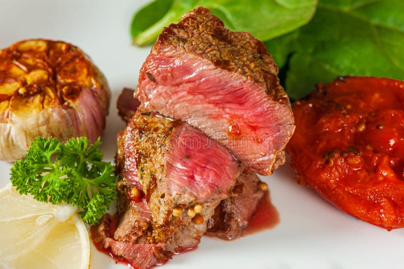 Steak With Blood Medium Rare With A Side Dish Of Tomatoes And ...