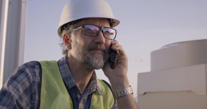 Engineer Having Phone Call on a Cell Tower Stock Photo - Image of ...