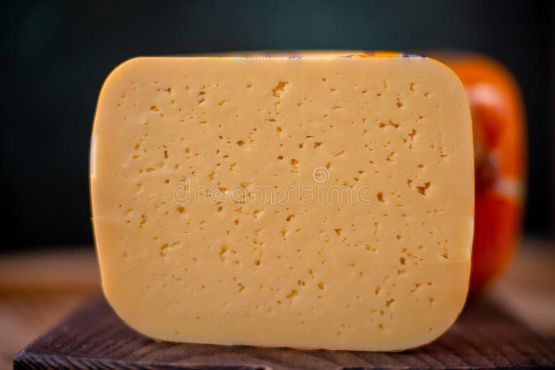 Medium Hard Cheese Gouda Edam on Wooden Board on Sunlight Table ...