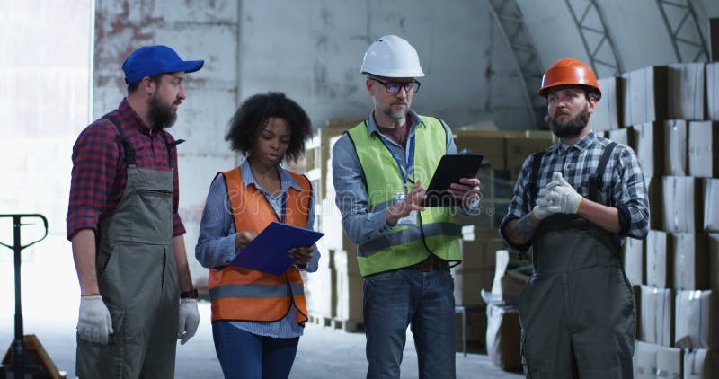 Engineer Giving Out Instructions in a Warehouse Stock Video - Video of ...