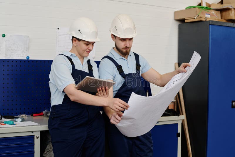 Two Engineers Looking at Technical Drawing Stock Image - Image of ...