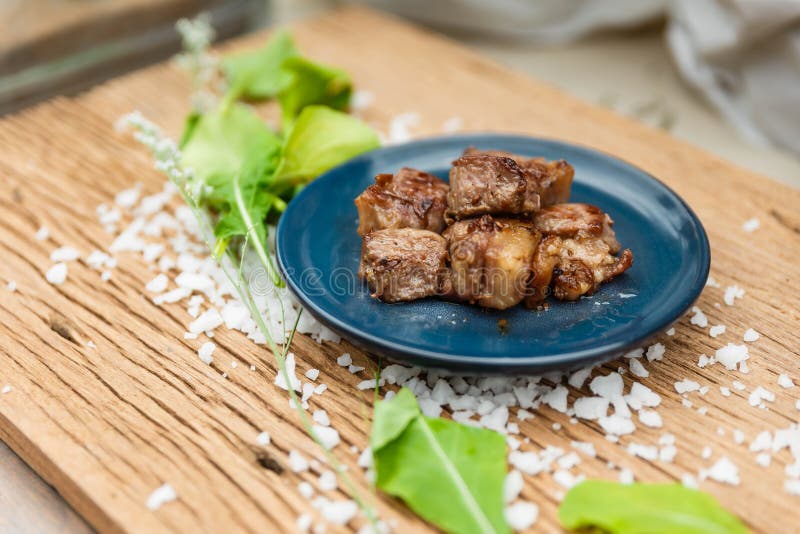 Medium Rare Fried Diced Marinated Beef on Blue Ceramic Plate on Wood ...