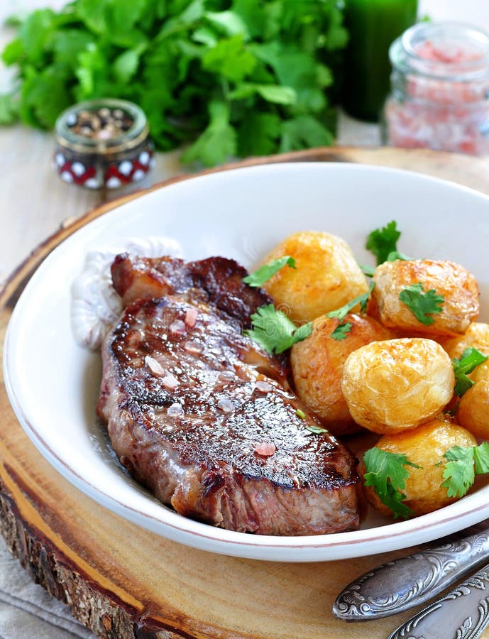 Medium Rare Grilled Beef Steak with Roasted Potato Stock Image - Image ...