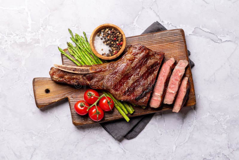 Medium Rare Grilled Tomahawk Beef Steak with Asparagus Stock Image ...