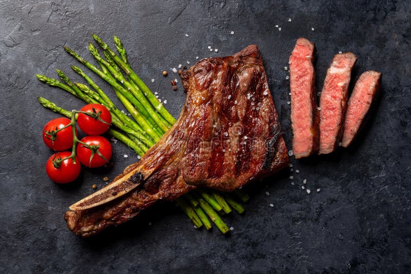 Medium Rare Grilled Tomahawk Beef Steak with Asparagus Stock Image ...