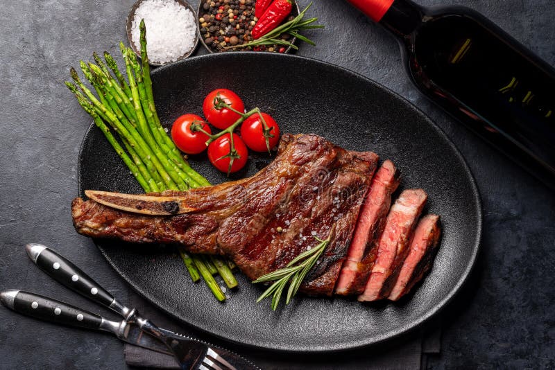 Medium Rare Grilled Tomahawk Beef Steak with Asparagus Stock Photo ...