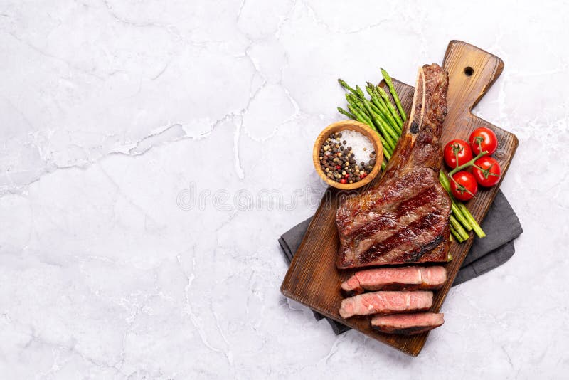 Medium Rare Grilled Tomahawk Beef Steak with Asparagus Stock Photo ...