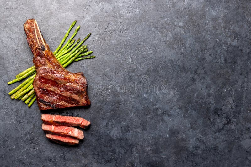 Medium Rare Grilled Tomahawk Beef Steak with Asparagus Stock Photo ...