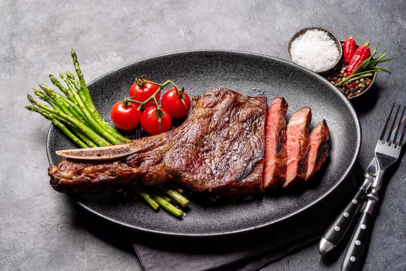 Medium Rare Grilled Tomahawk Beef Steak with Asparagus Stock Photo ...