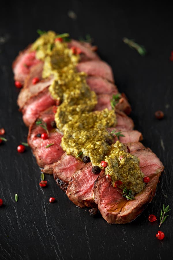 Medium Rare Venison Steak with Green Pesto Sauce and Pepper Stock Image ...