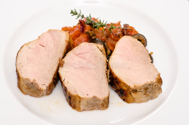 Medium roasted pork fillet stock image. Image of tomatoes - 39896899