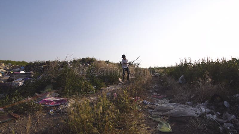 Angry boy walking in dump stock footage. Video of path - 153073088