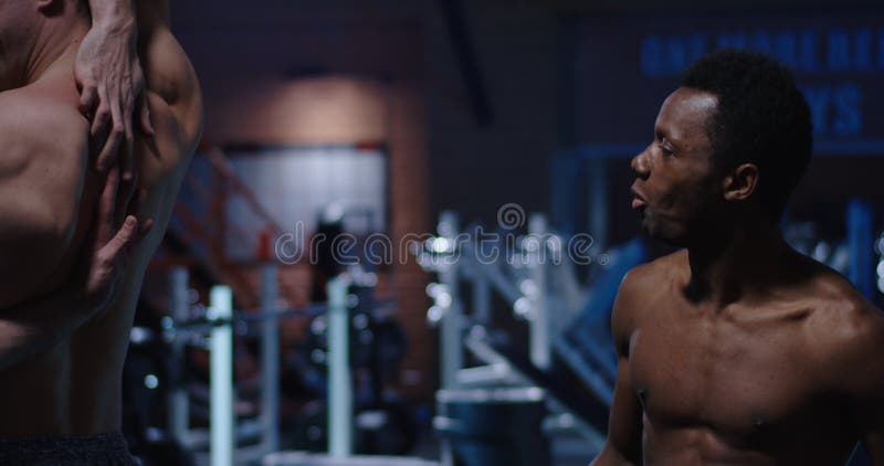 Body Builder and Regular Man Showing Muscles Stock Footage - Video of ...