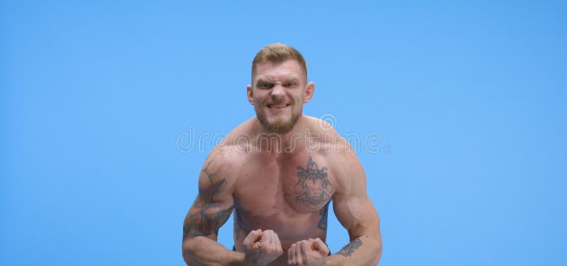 Buff man flexing his arms stock photo. Image of strong - 166308478