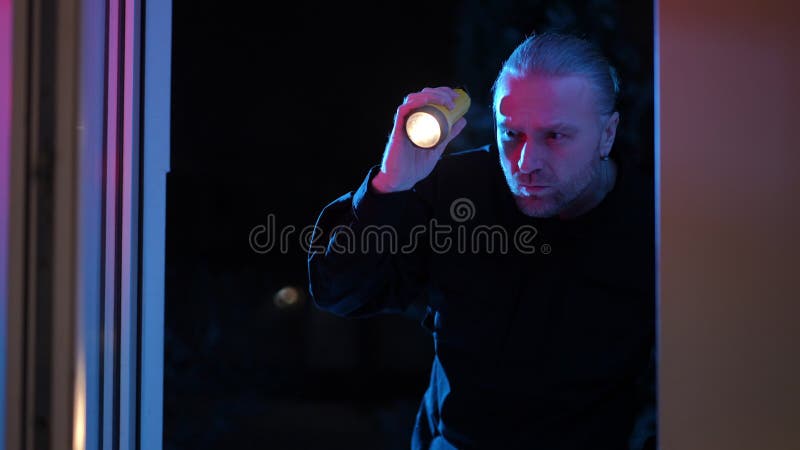 Medium Shot of Concentrated Caucasian Patrolman with Flashlight Looking ...