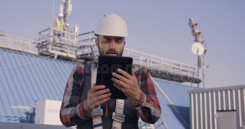 Engineers Using a Tablet on a Cellular Tower Stock Image - Image of ...