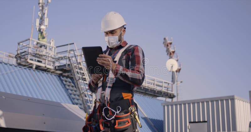 Engineers Using a Tablet on a Cellular Tower Stock Image - Image of ...
