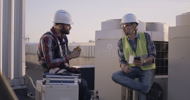 Engineers Having a Break on a Cell Tower Stock Image - Image of ...