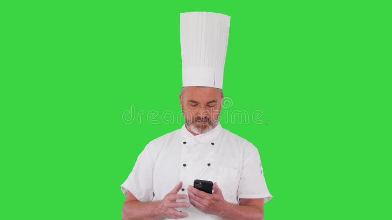 Mature Chef in White Uniform Texting a Message on His Cellphone on a ...
