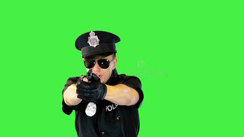 Policeman in Uniform Runs Aiming with a Gun on a Green Screen, Chroma ...