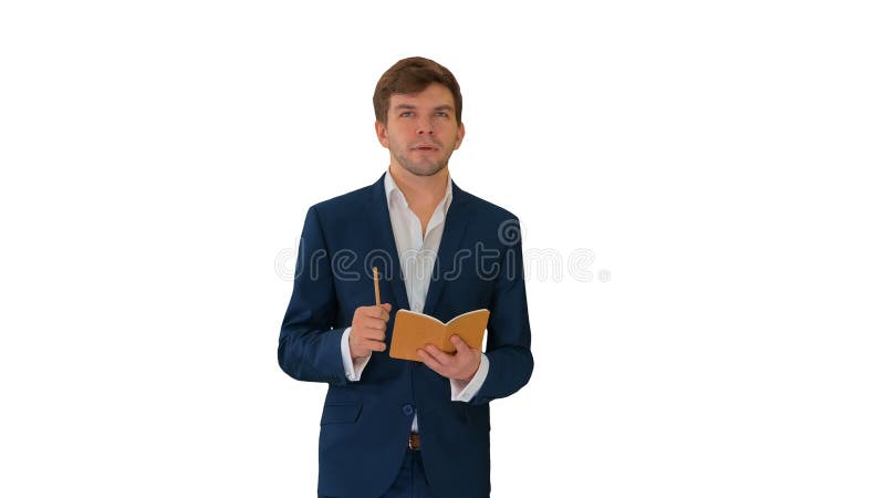 Young Businessman Thinking and Writing Notes in His Notebook Whi Stock ...