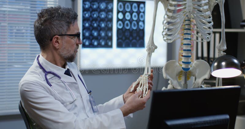 Doctor Using Skeleton Model for Analyzing Hand Anatomy Stock Footage ...