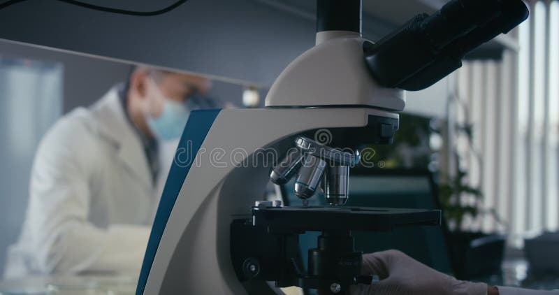 Scientists Studying Samples in Microscope Stock Video - Video of male ...