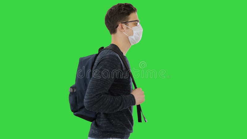 Student in Protective Masks Walking with Backpack on a Green Screen ...
