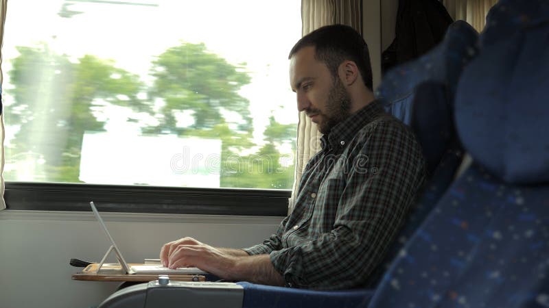 Sleepy Man Working in Tablet in Train Sitting by a Window. Stock Image ...