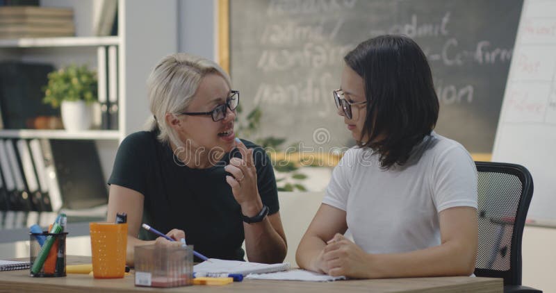Teacher Explaining To Student in a Classroom Stock Image - Image of ...