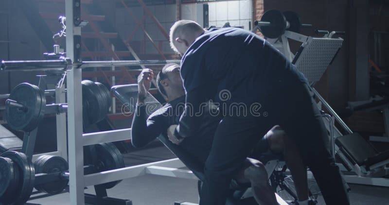 Trainer Lifting Disabled Man Onto Training Bench Stock Footage - Video ...