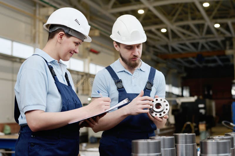 Two Factory Workers Checking Metal Parts Stock Image - Image of safety ...