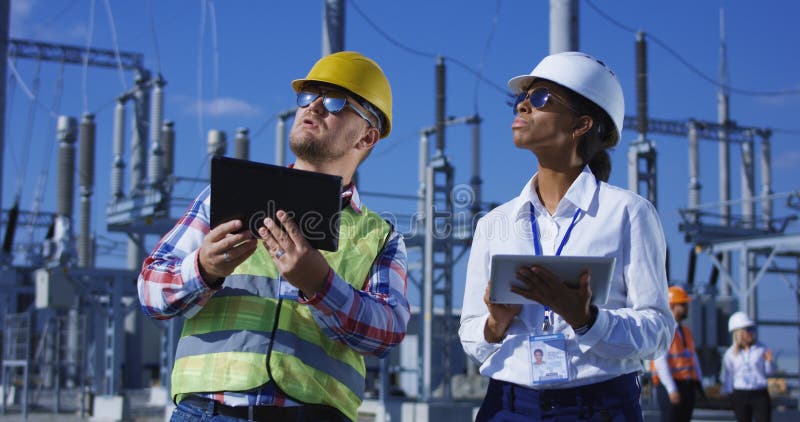 Two Electrical Workers on Tablets Outside Stock Photo - Image of ...