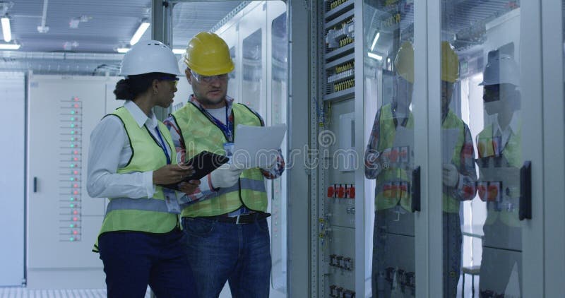 Two Electrical Workers Walking in the Control Room Stock Photo - Image ...