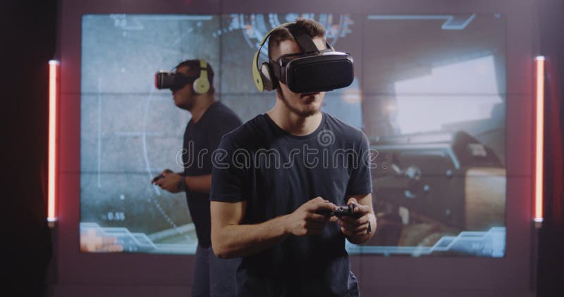 Young men playing VR game stock image. Image of game - 154368097